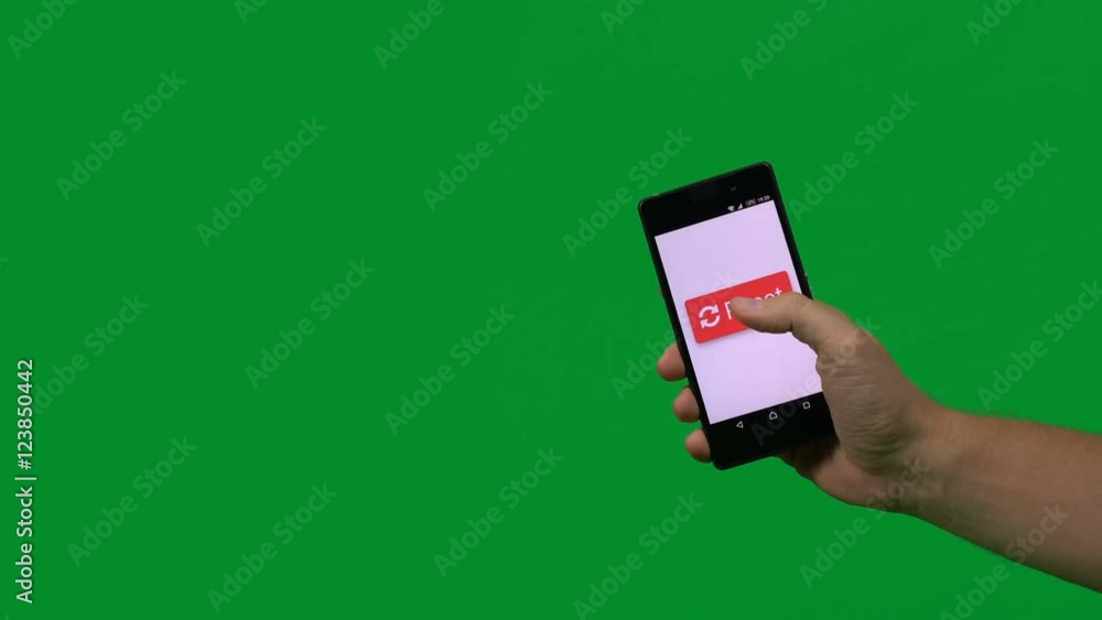 Hand holding a phone pressing the reset button, shot on a green screen ...