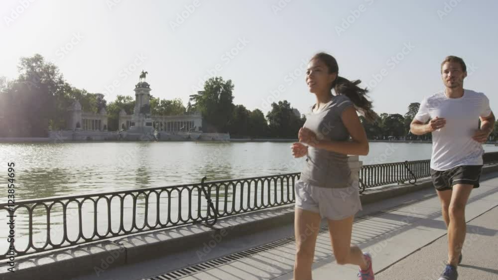 Runners jogging running in Madrid El Retiro city park. Exercising woman ...