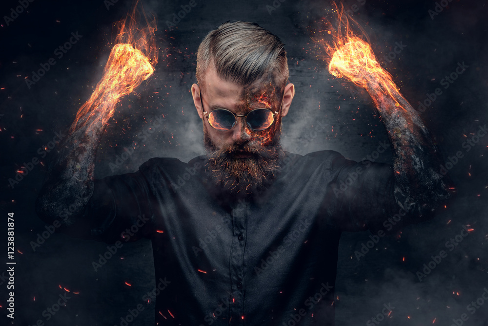 Foto de Demonic man with burning arms. do Stock | Adobe Stock