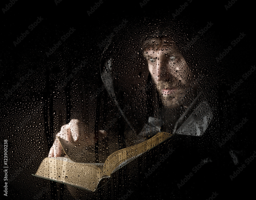 necromancer casts spells from thick ancient book, behind transparent ...