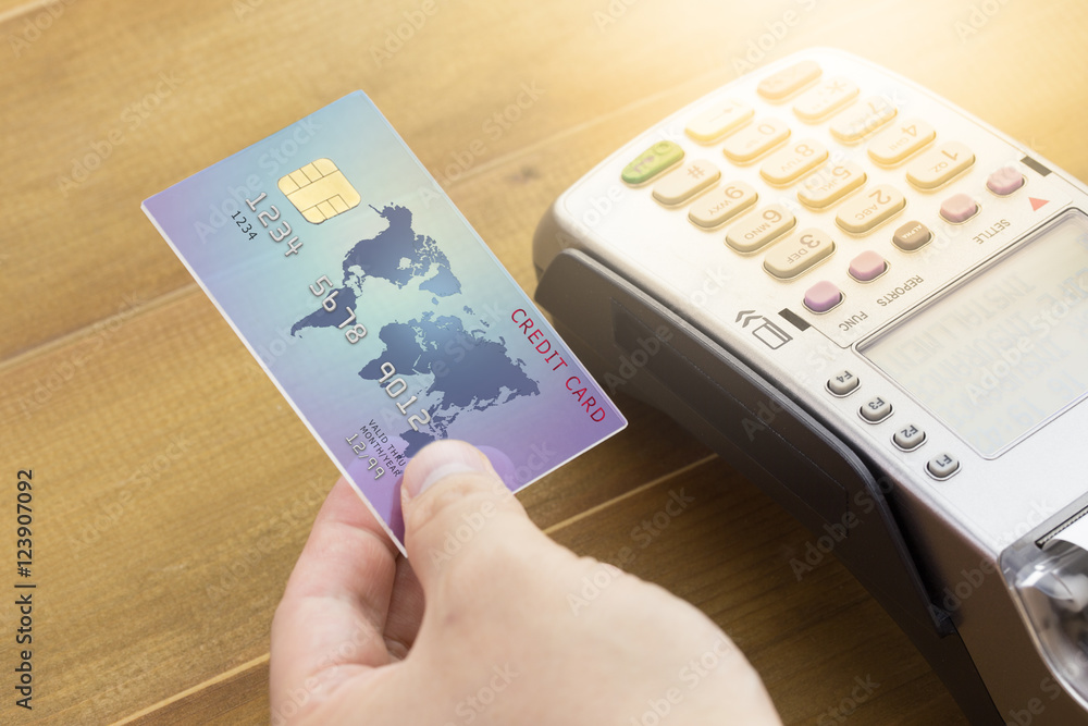 Cashier hand holding a Credit card and EDC machine or credit card ...