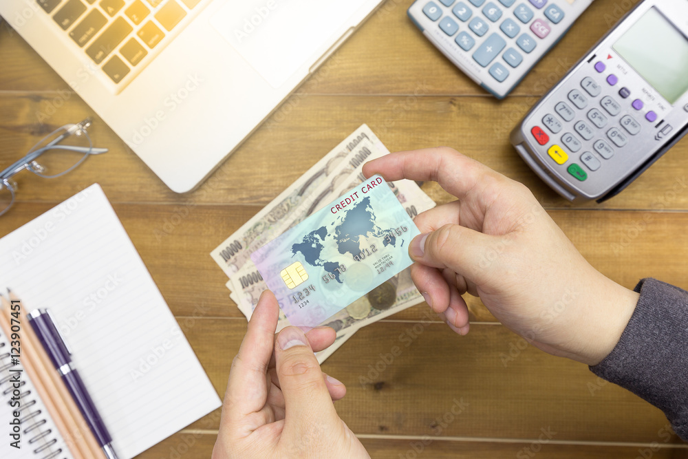 Cashier hand holding a Credit card over EDC machine or credit card ...