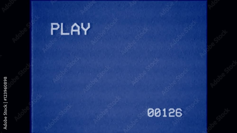 An old bad VHS tape playing. Blue screen with PLAY text and timer. A ...