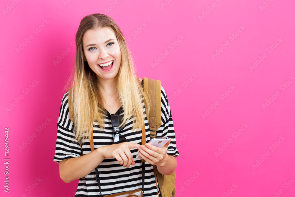 Young woman using her phone Stock Photo | Adobe Stock