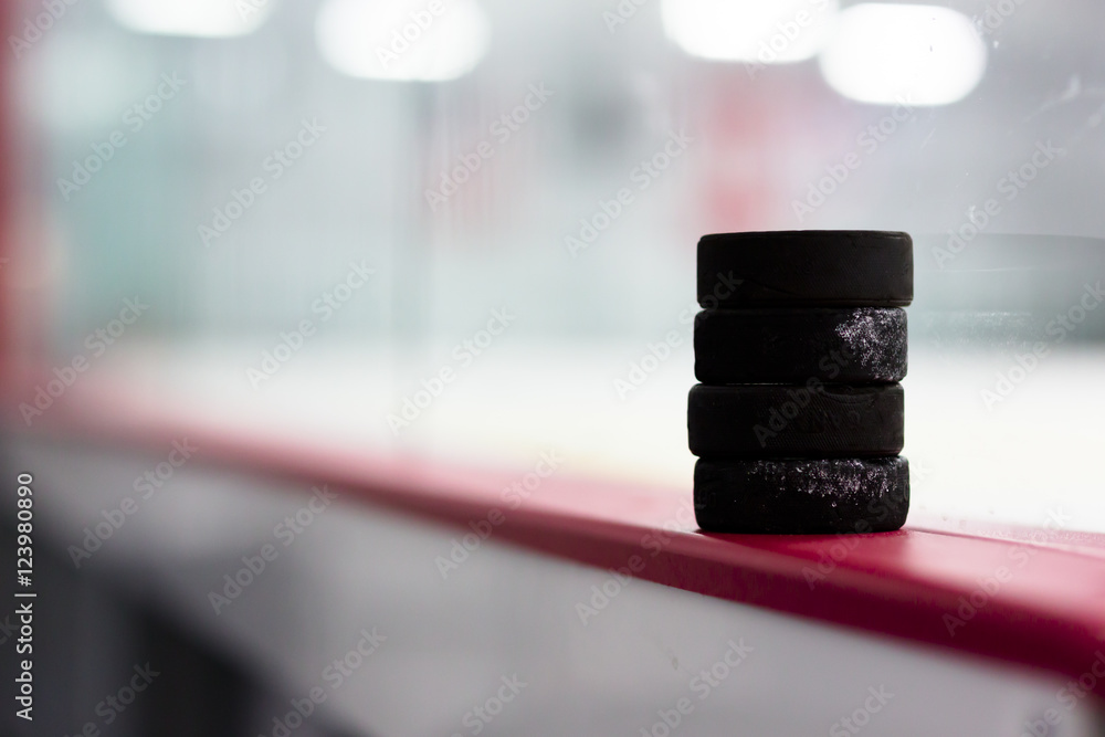 Hockey pucks along the boards Stock Photo | Adobe Stock