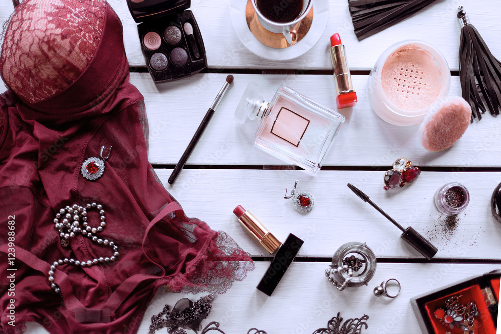 Female bodystocking with cosmetic and accessories on white background ...