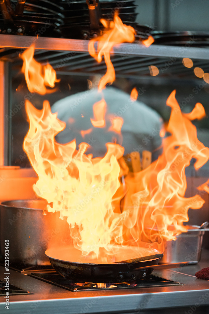 Flambe Chef Cooking in Outdoor Kitchen. Professional chef in a ...