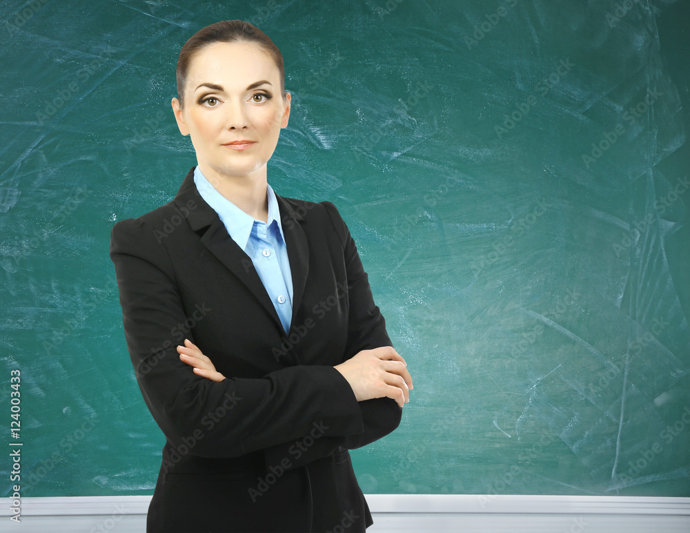 Portrait of young teacher on chalkboard background Stock Photo | Adobe ...
