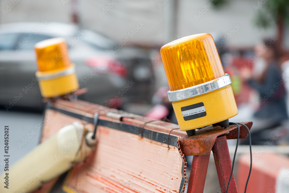 Rotating warning lights direct traffic away from a construction site ...