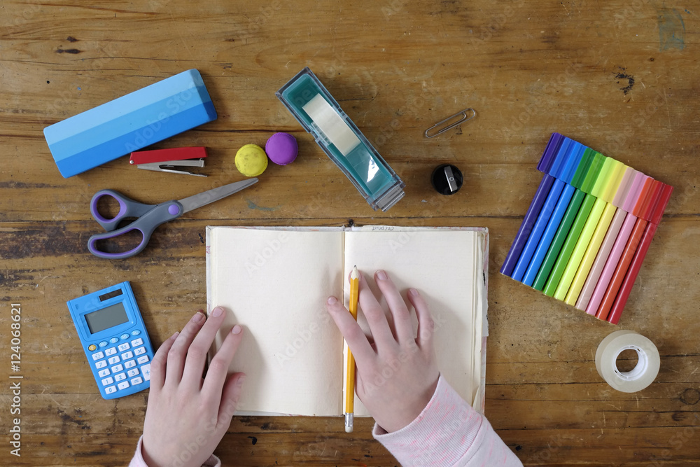 Overhead view of Hands at a desk with school homework objects Stock ...