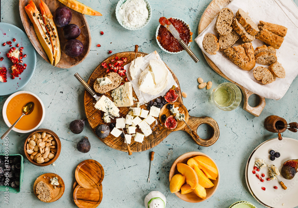 Gourmet food table. Various cheese, fruits and jam over gourmet table ...