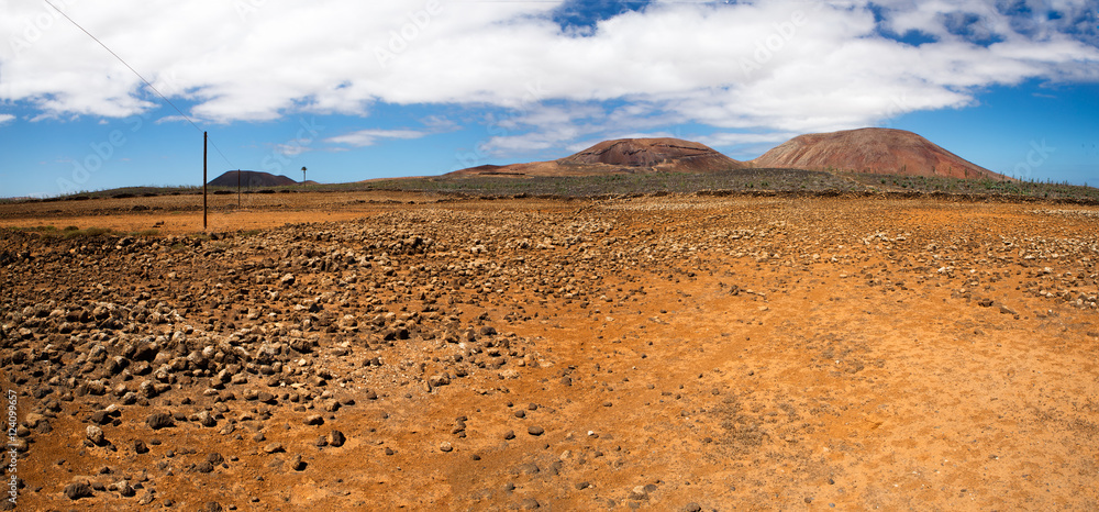 rocky and dry plain with mountains in the background Stock Photo ...