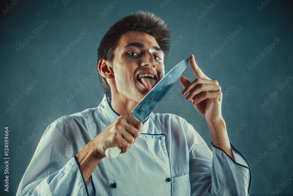 Evil waiter with wolf eyes is cleaning the knife with the tongue Stock ...