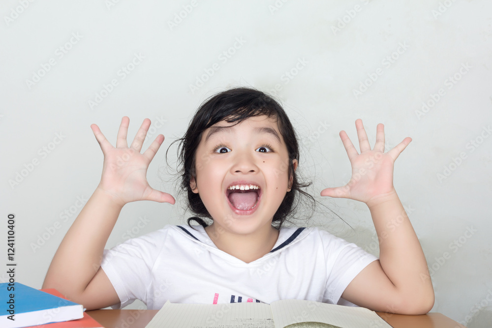 Foto de Happy Asian child hands up do Stock | Adobe Stock