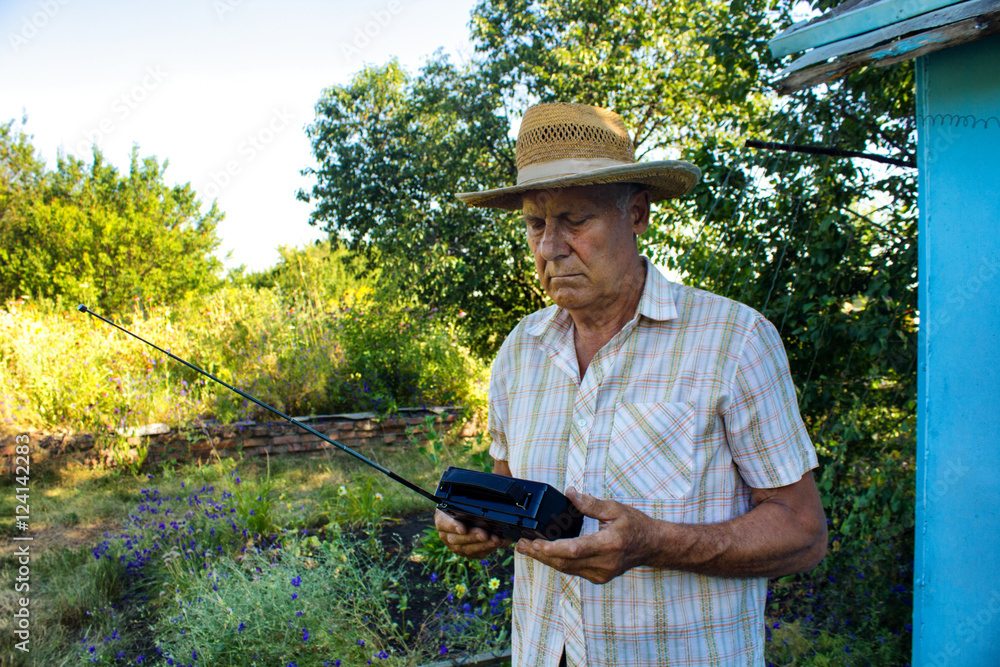 Old man listening to radio Stock Photo | Adobe Stock