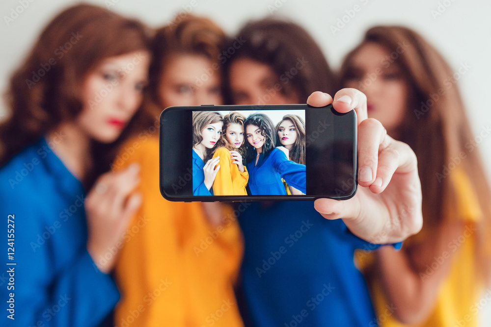 Fashion girls in bright clothes make selfie. Beautiful women with ...