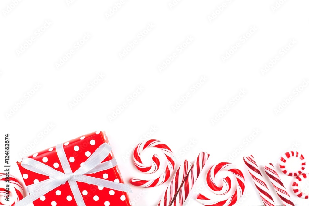 Christmas border of red and white gifts and peppermint candies over a ...