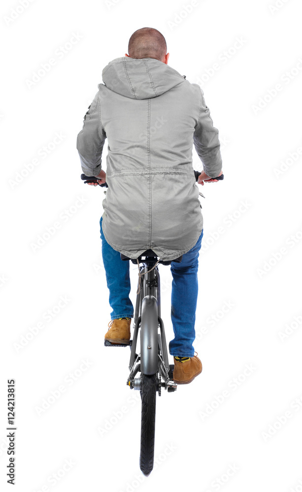back view of a man with a bicycle. cyclist rides a bicycle. Rear view ...