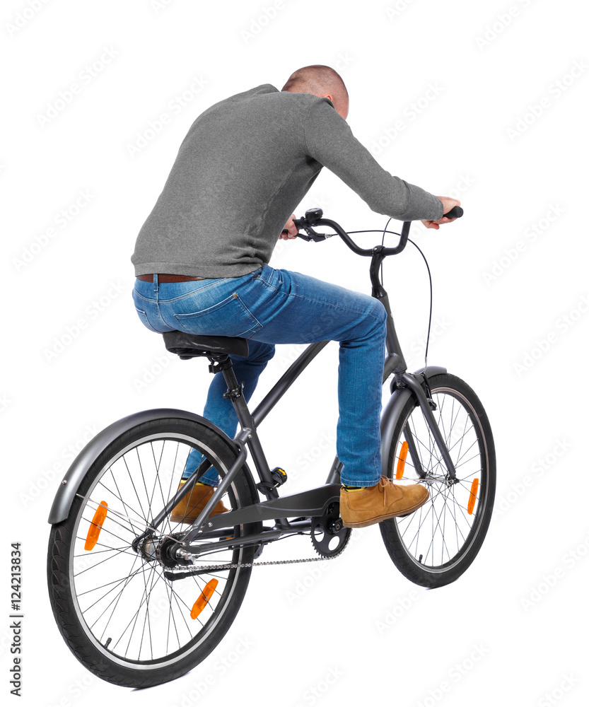 back view of a man with a bicycle. cyclist rides a bicycle. Rear view ...