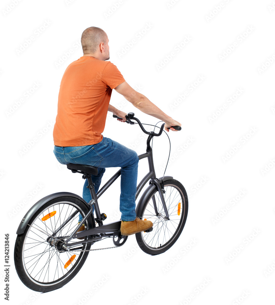 back view of a man with a bicycle. cyclist rides a bicycle. Rear view ...