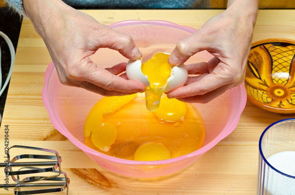Making cookies. Chacking eggs. Stock Photo | Adobe Stock