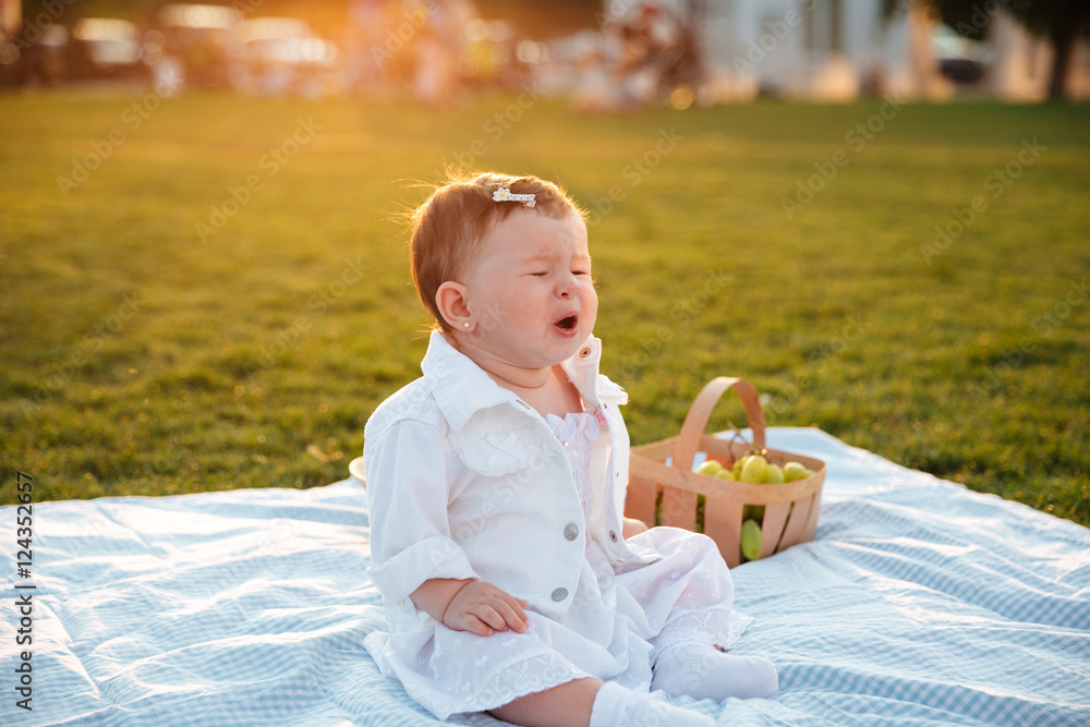 Cute little baby crying alone in park Stock Photo | Adobe Stock