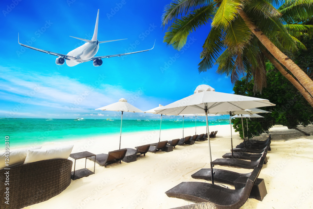 Airplane flying over amazing tropical beach with palm tree, white sand ...