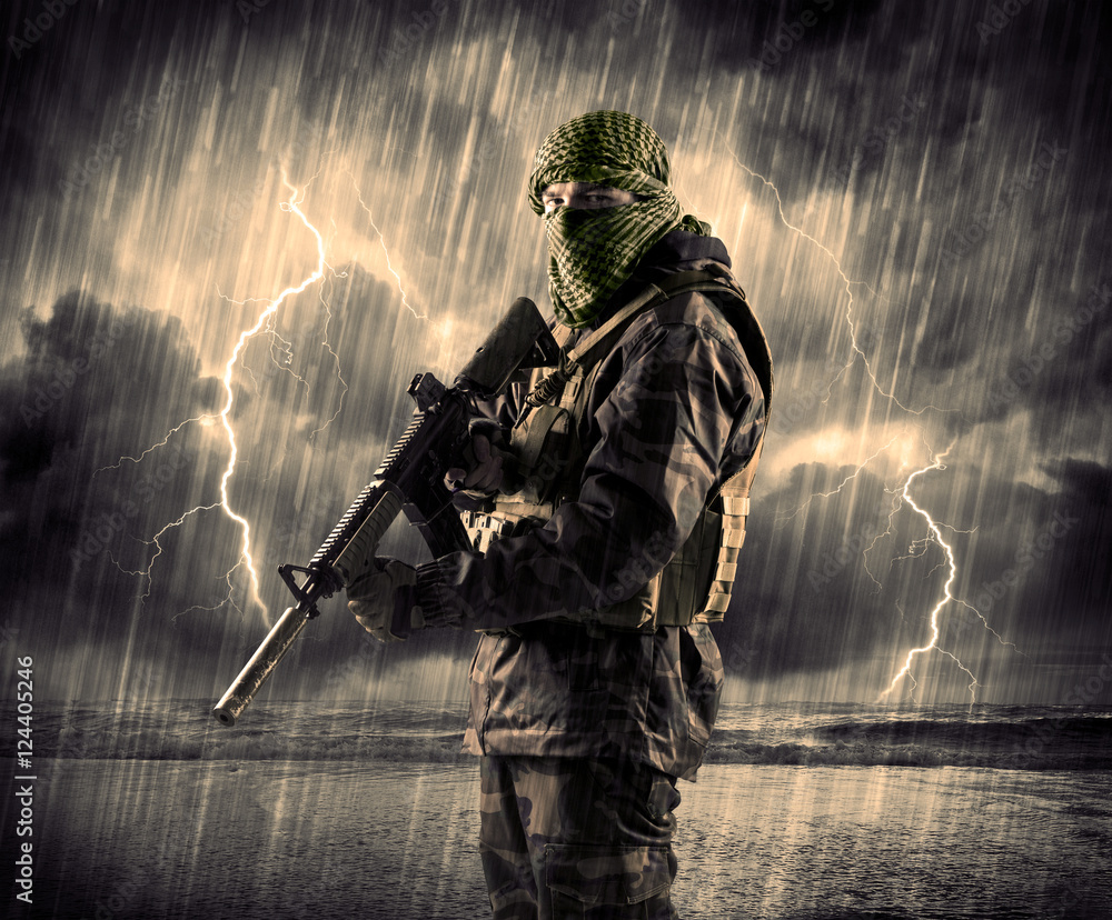 Dangerous armed terrorist with mask and gun in a thunderstorm wi Stock ...