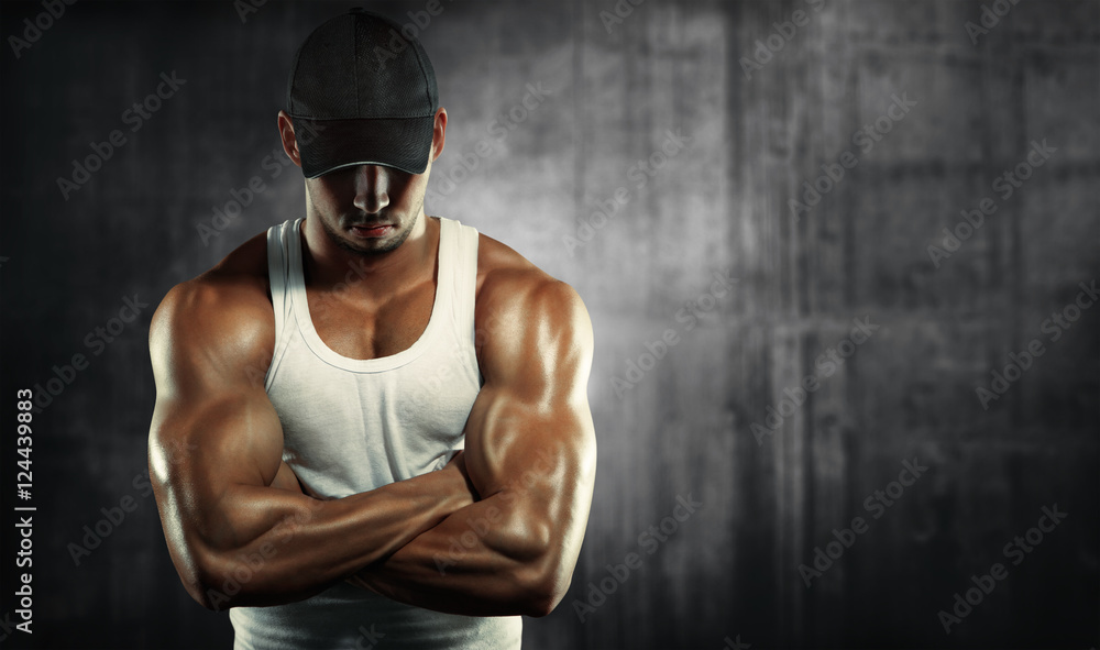Sports background. Bodybuilding. Strong man posing on a concrete ...