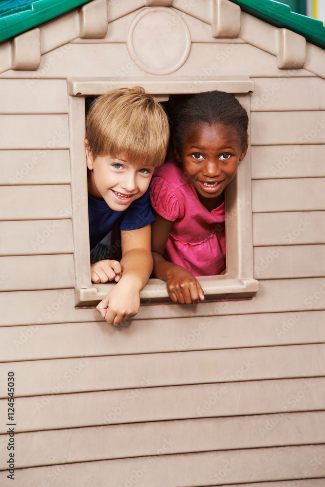 Two children looking through window in playhouse Stock Photo | Adobe Stock