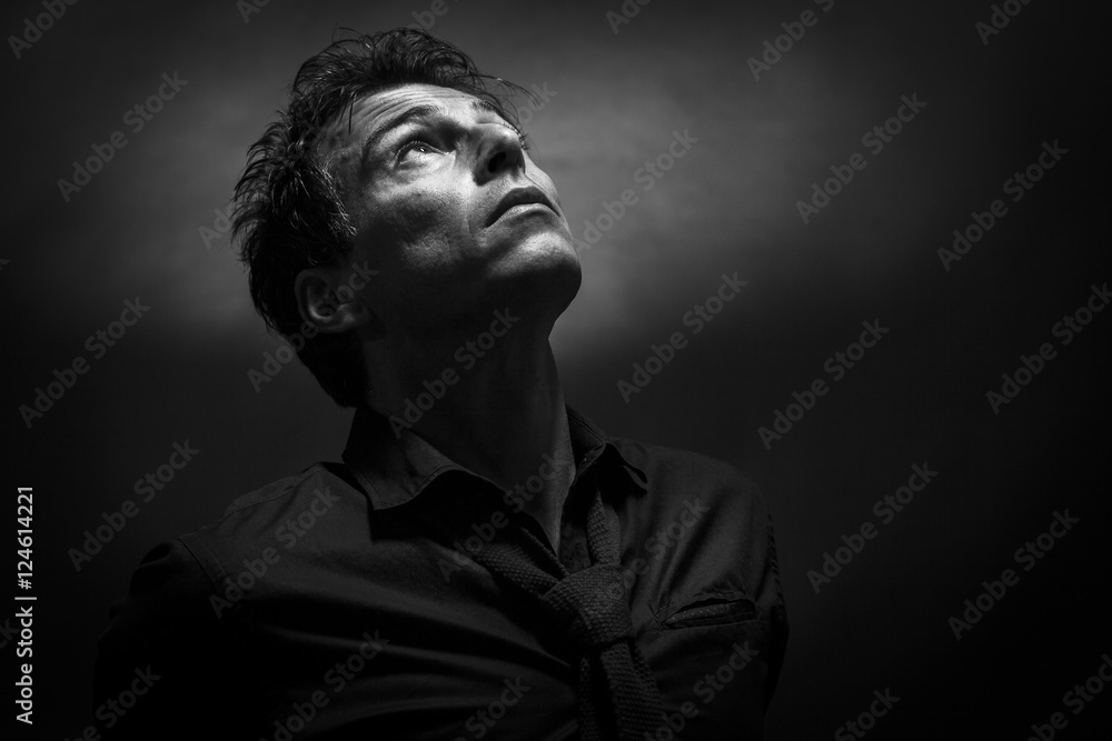 Isolated thinking man face looking up. Low key , black and white ...