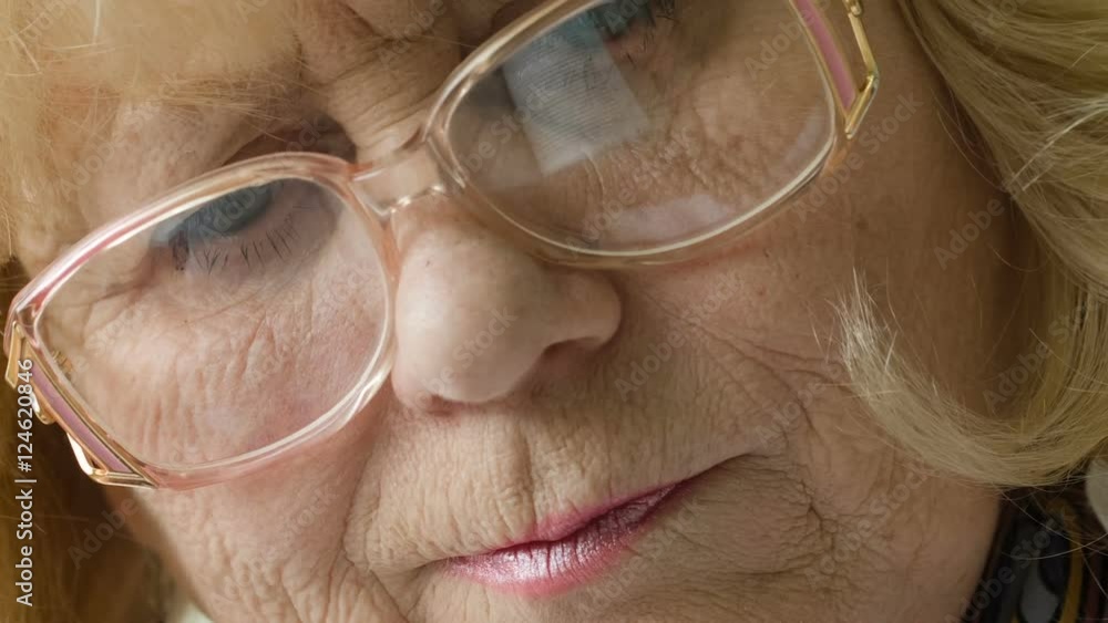 Old lady in glasses flipping through the book. Stock Video | Adobe Stock