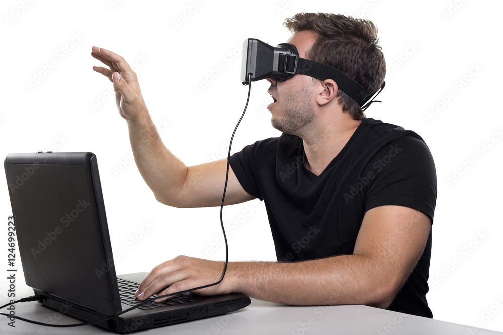 Virtual Reality gamer wearing headset tethered to a gaming pc Stock ...