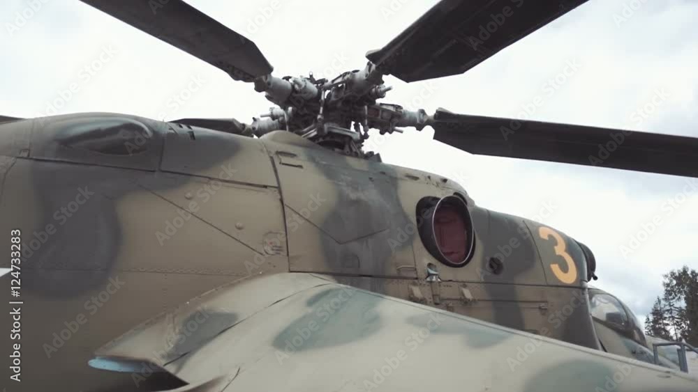 Military attack helicopter Mi-24 standing on the airport. Center of ...