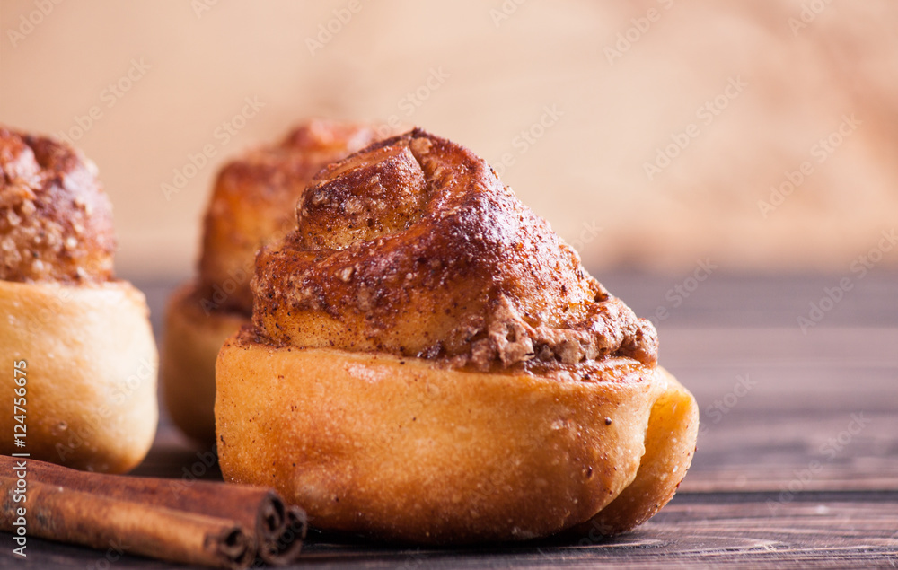 Cinnamon bun on wood background Stock Photo | Adobe Stock