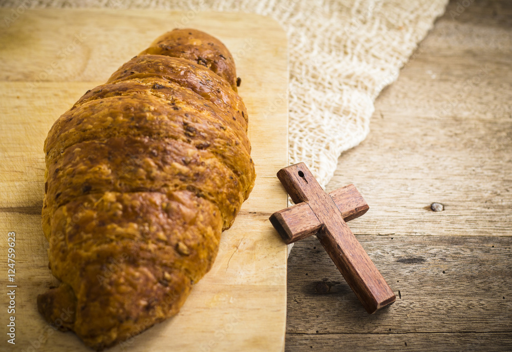 The crucifix of jesus and the compass on holy bible with on wooden ...
