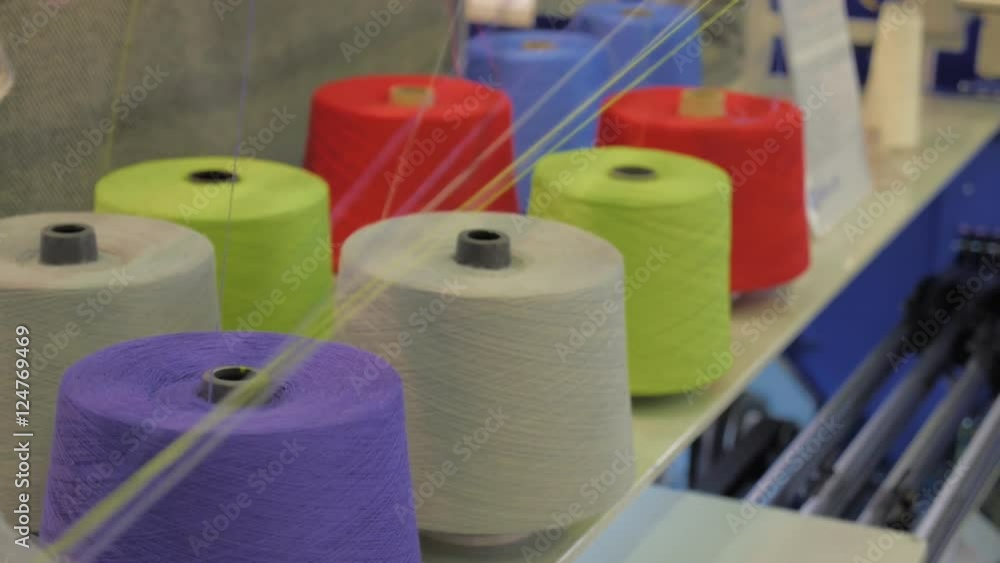 Video Stock Rows spools of thread of different colors in the industrial ...