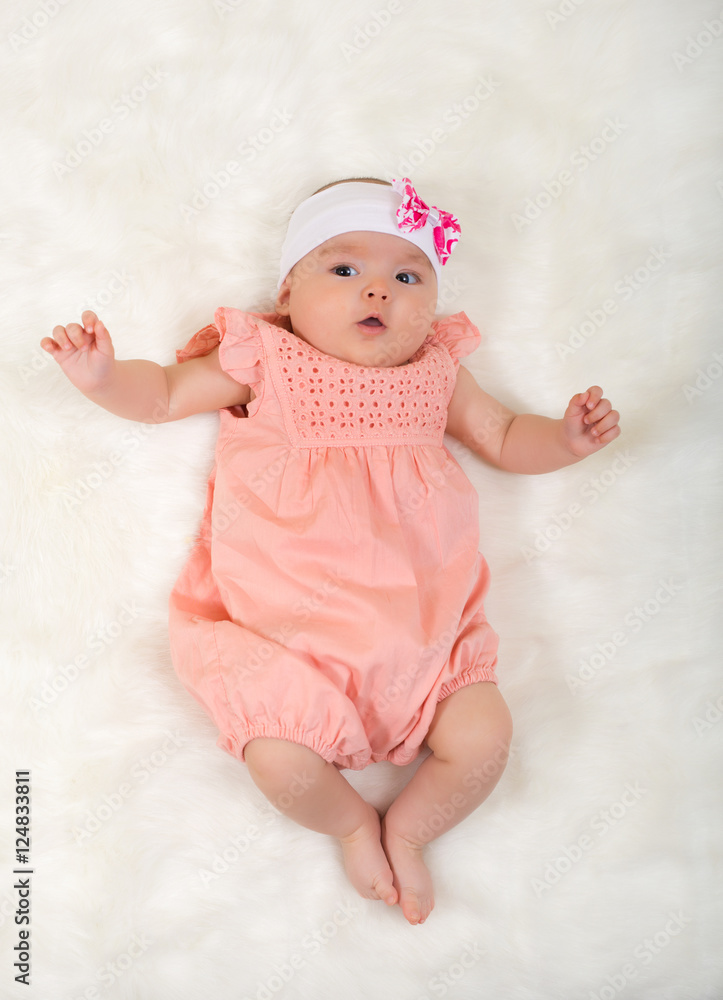 Cute baby girl lying on her back Stock Photo | Adobe Stock