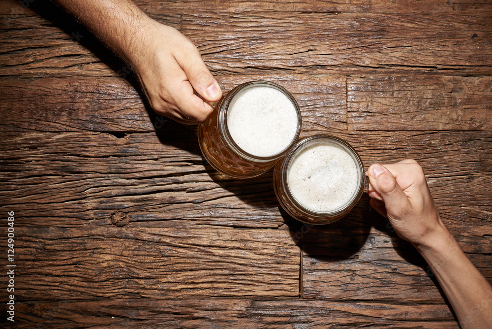 Hände beim anstoßen mit Bier Stock-Foto | Adobe Stock