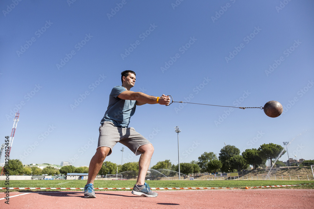 Athlete performing a hammer throw Stock Photo | Adobe Stock