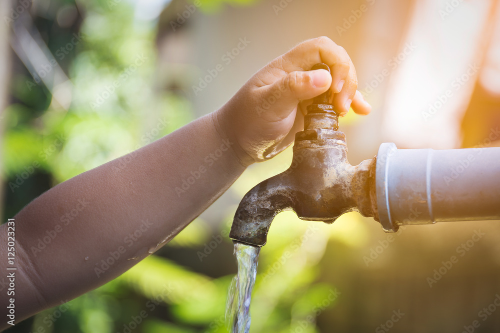 Child open water valve Stock Photo | Adobe Stock