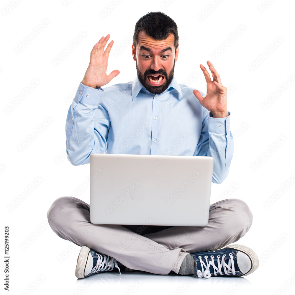 Frustrated man with laptop Stock Photo | Adobe Stock