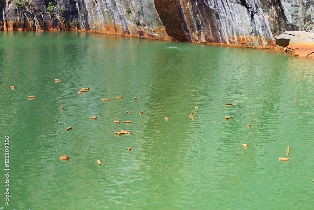 Copper lake with copper colored glass bottles inside. Next to the ...