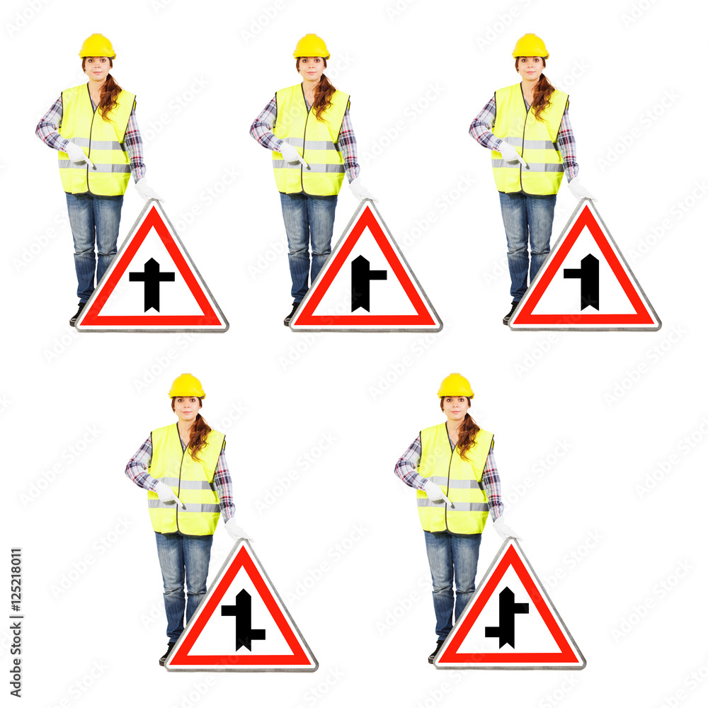 Attractive woman in construction helmet and uniform with road signs ...
