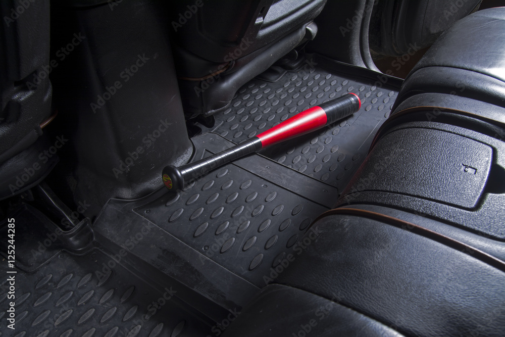 Baseball bat in the back seat of the car. Stock Photo | Adobe Stock