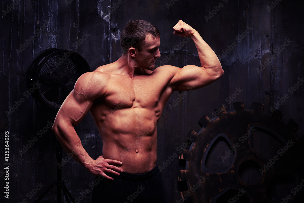 Shirtless man flexing muscles showing great relief of his arms a Stock ...