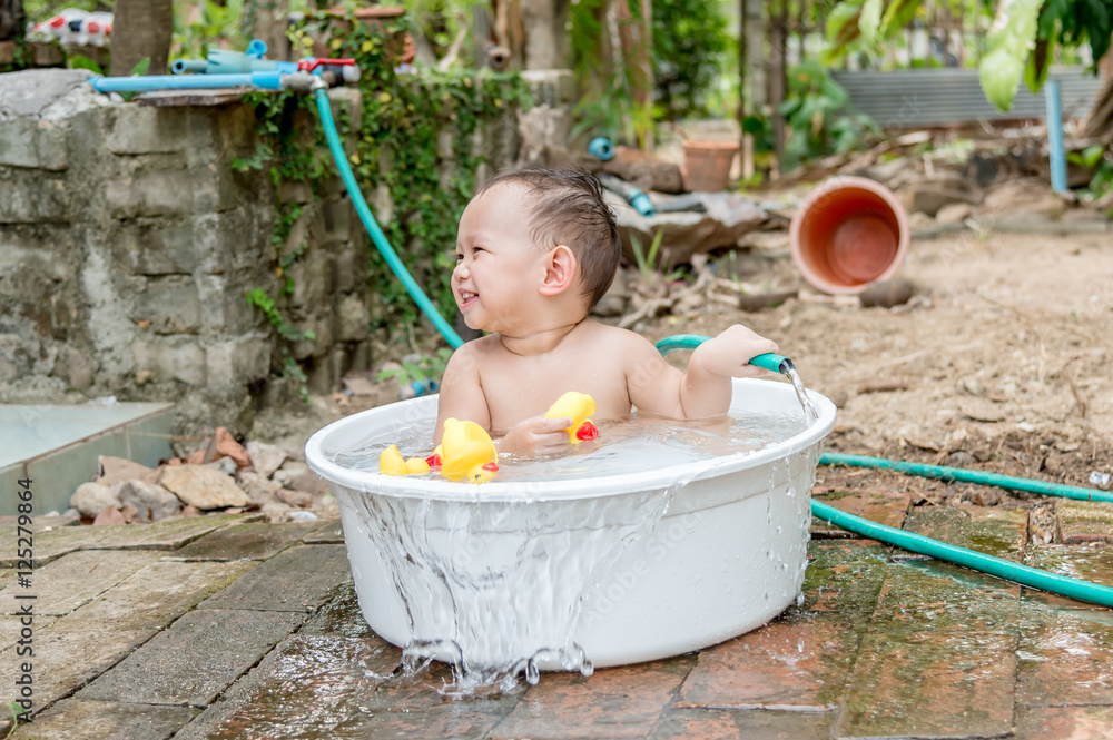 Top view Asian baby boy outdoor bathing in the white bathtub . H Stock ...