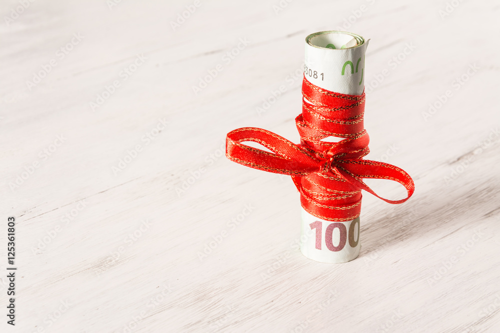 the best gift- money. Gift on wooden background. Stock Photo | Adobe Stock
