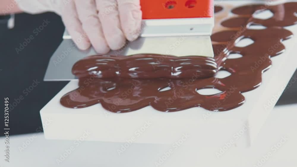 Making chocolates. Chocolatier in the process. The body of chocolates ...