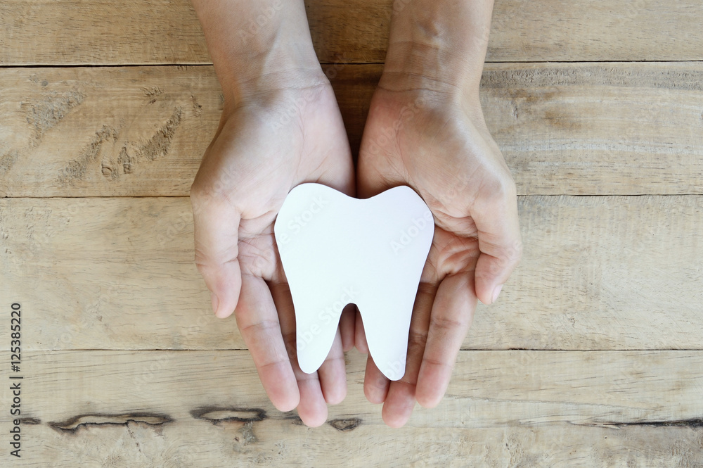 teeth in woman hand Stock Photo | Adobe Stock